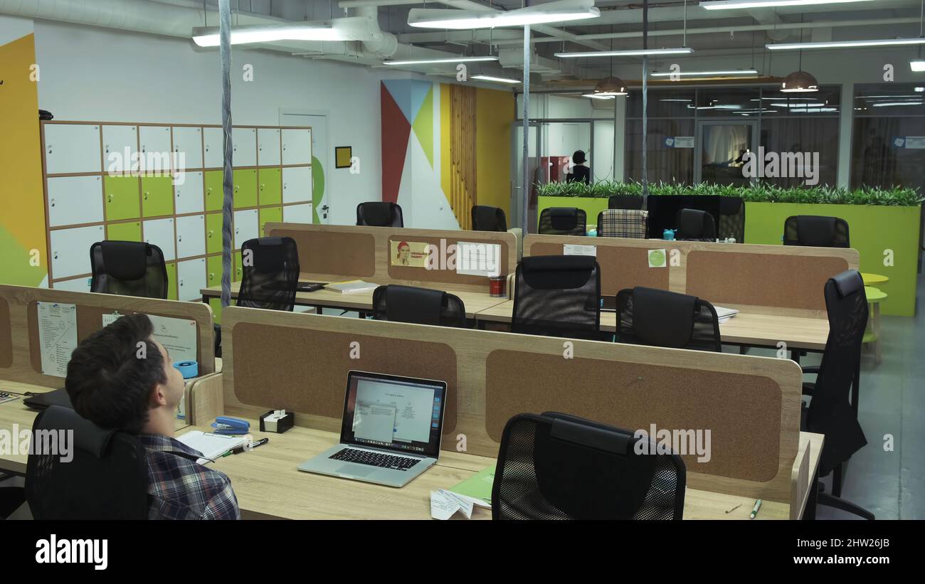 Almost empty open space office with bright walls with comfortable ...