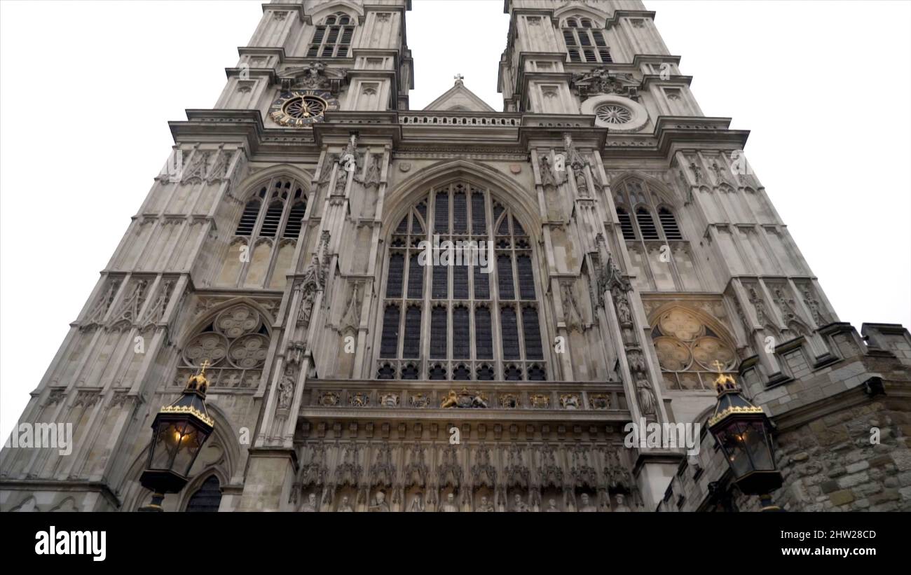 Facade of cathedral with two towers on background of cloudy sky. Action ...