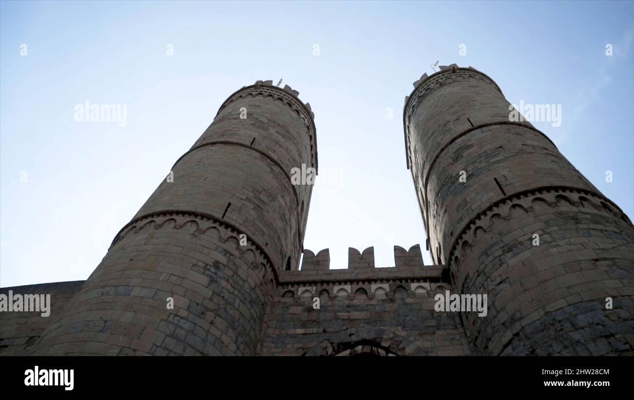Bottom view of old fortress towers. Action. Two towers of old castle ...