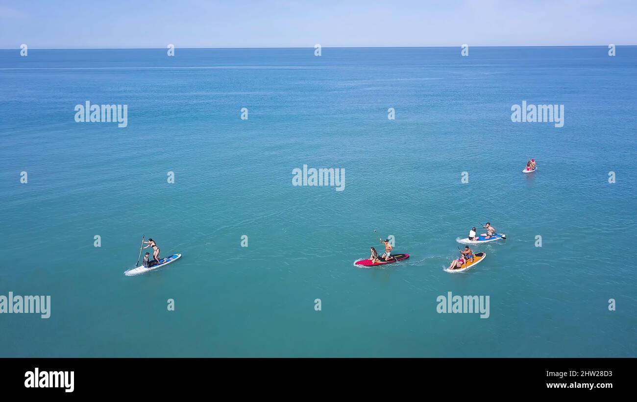 Group of people swim on SUP Board. Clip. Beautiful seascape with people ...