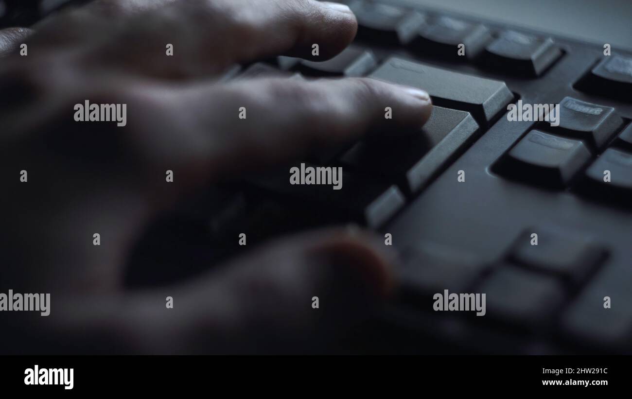 Close-up man presses keyboard key. Man presses button enter computer ...