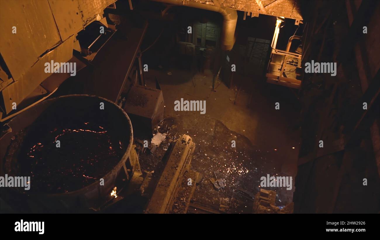Metal smelting in steel mill furnace. Footage. Top view on pot of ...