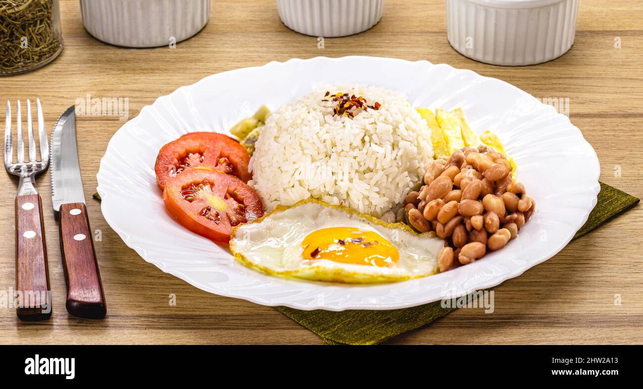plate of rice and beans typical of Brazil, fried sausage, fried egg ...