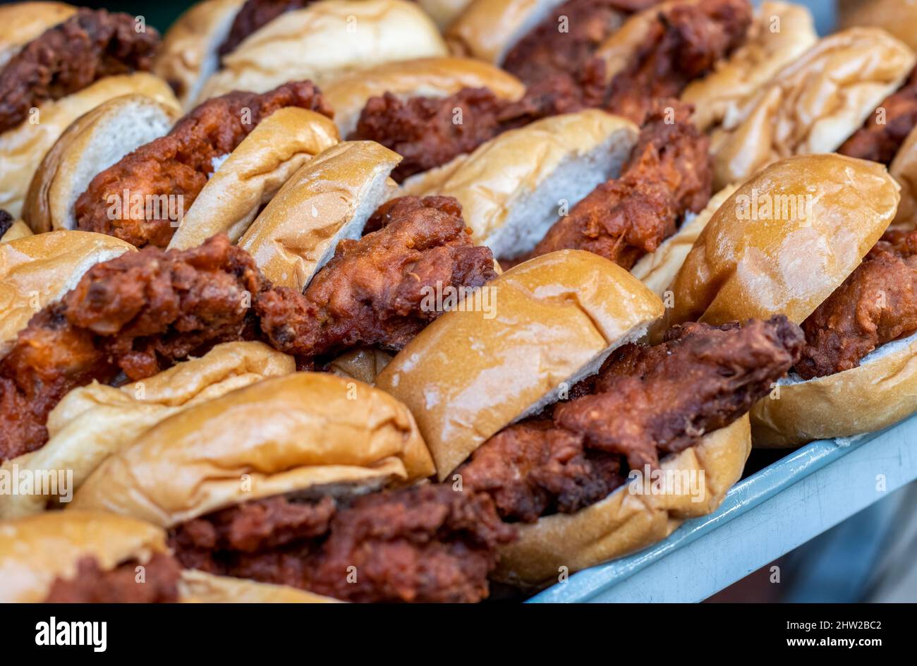 A pile of decorative delicious chicken burgers on the street market ...