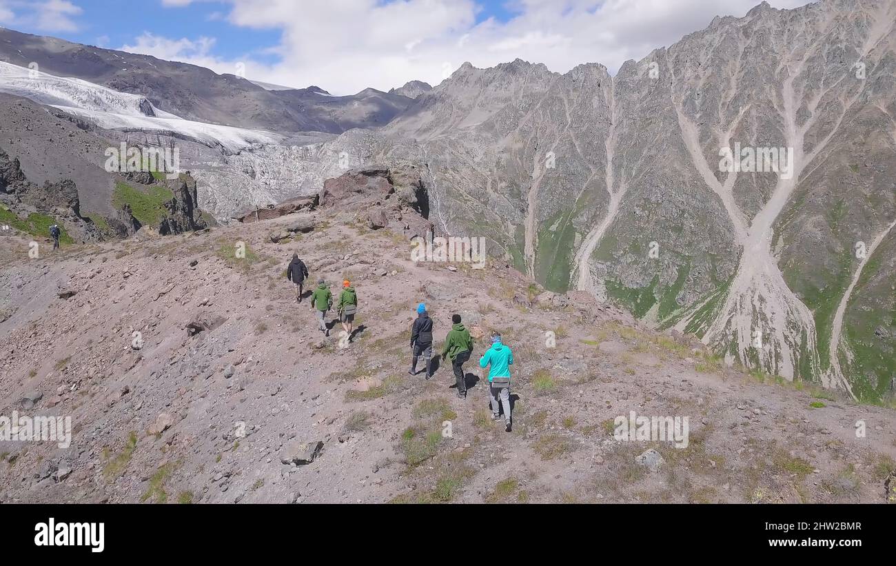Top view of climbers walking to rocky mountain with snow peak. Clip ...