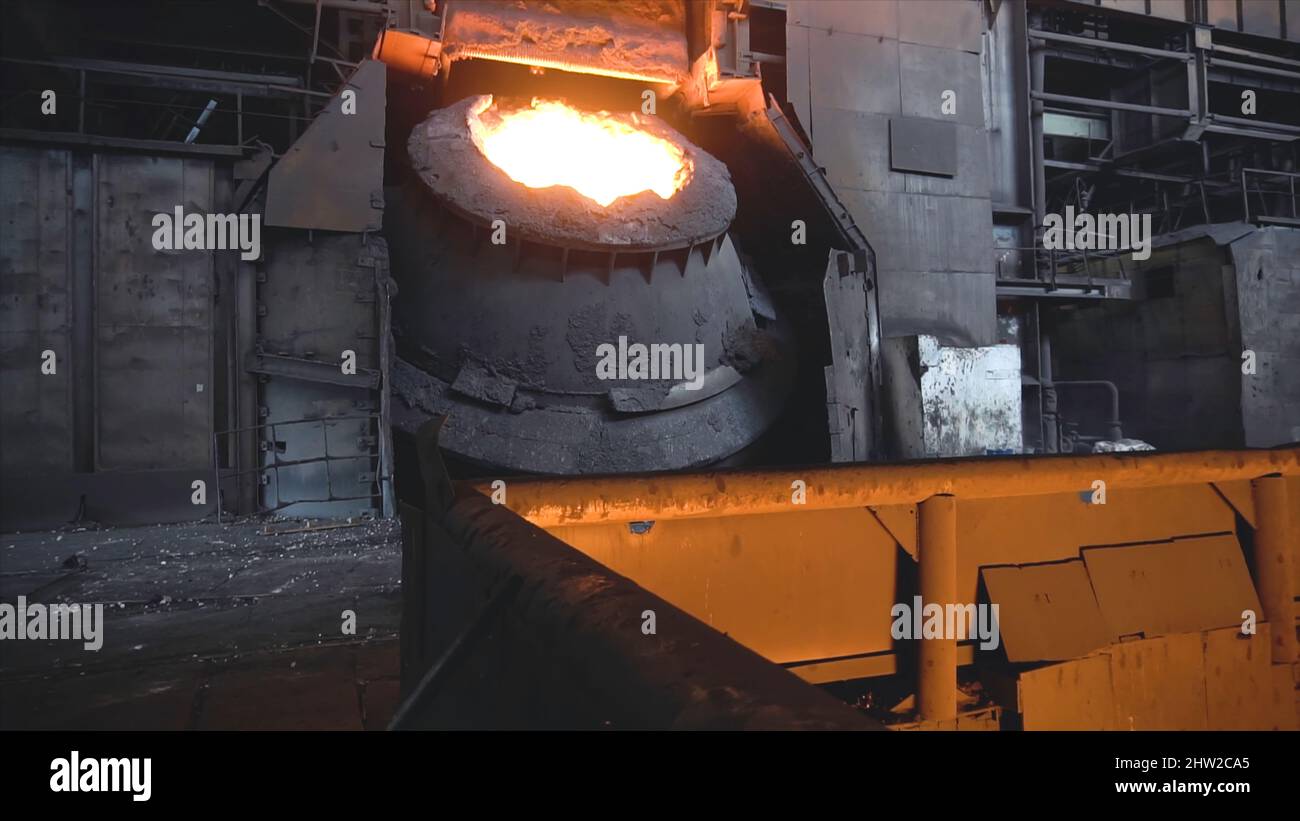 Metal smelting in steel mill furnace. Footage. Top view on pot of ...