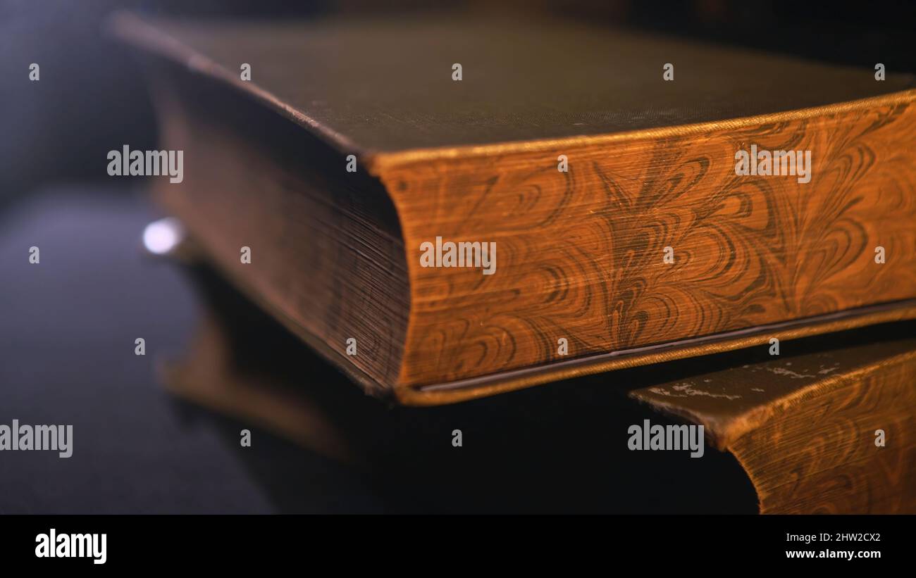 Vintage books, close-up. Pile of old books lying on the table in the dark room Stock Photo - Alamy