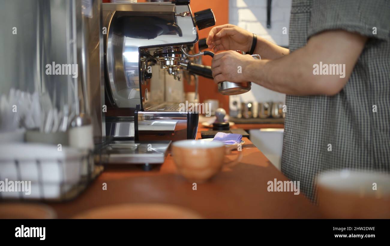 Close-up of professional barista pours coffee from coffee machine. Art ...
