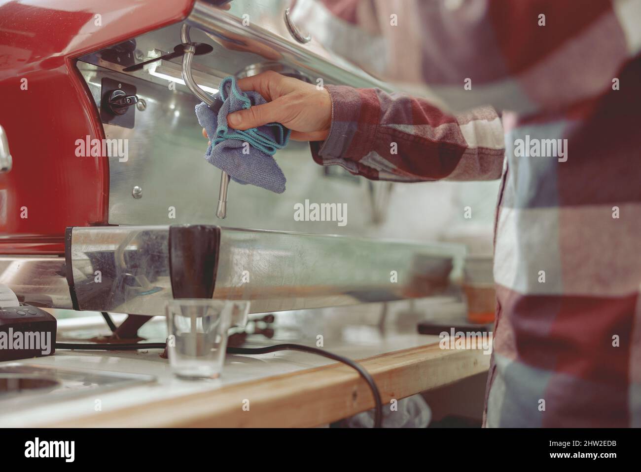 Barista cleaning the steam faucet of coffee machine Stock Photo - Alamy
