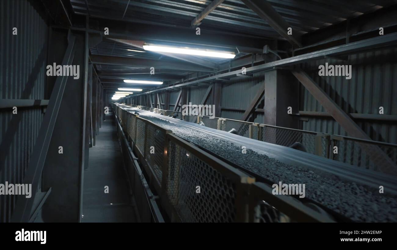 Close up of rubble moving on the conveyor, mining industry concept ...