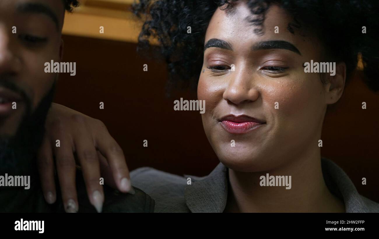A black couple together in conversation talking Stock Photo - Alamy