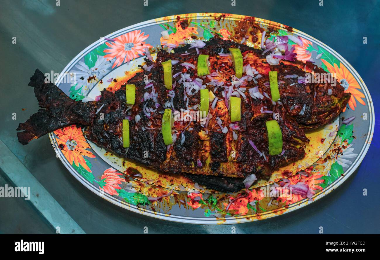 Grilled fish, sea bream with the addition of spices, herbs, and lemon ...