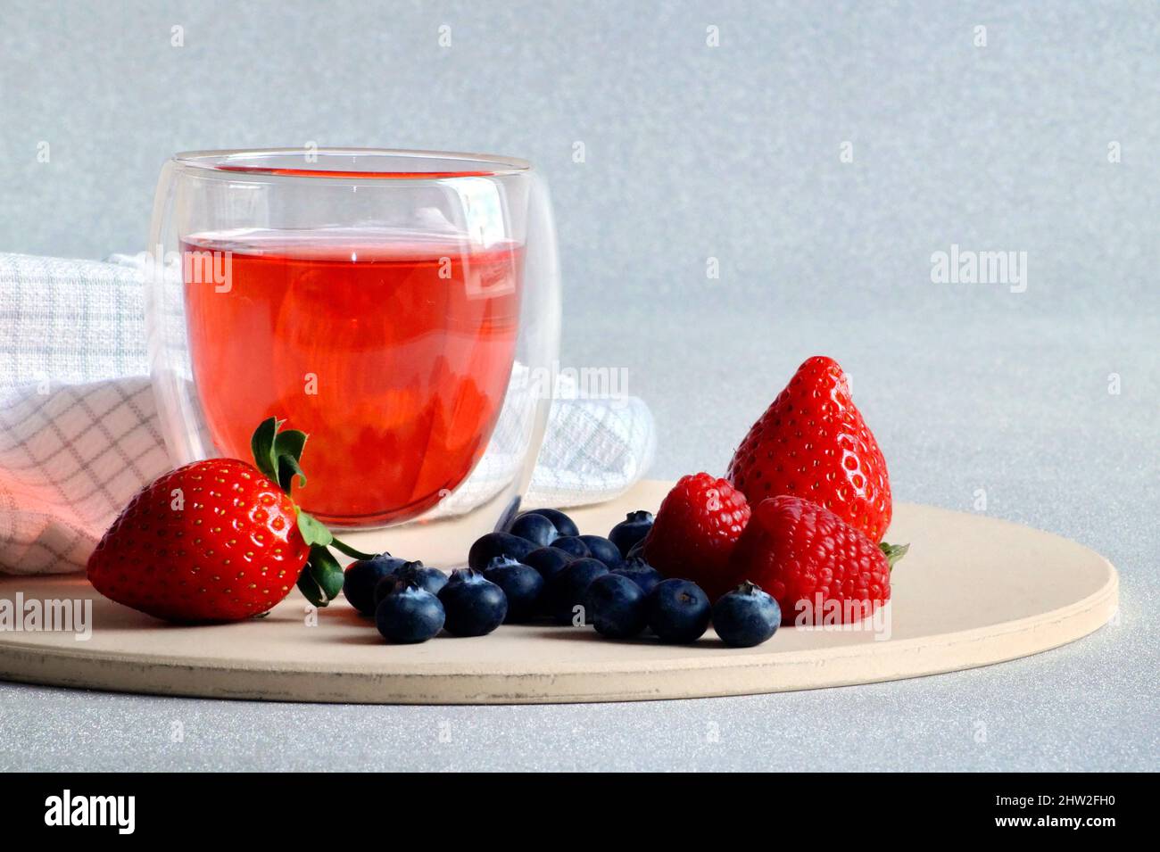 beautiful berry jelly in a transparent glass, fresh berries are ...