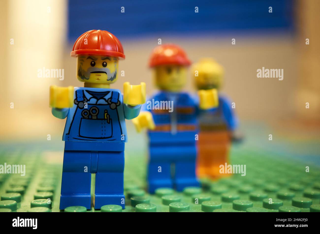 Closeup shot of construction workers toy figures team with red helmets ...
