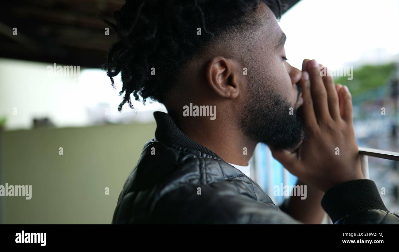 A Brazilian man praying to God opening eyes smiling Stock Photo - Alamy