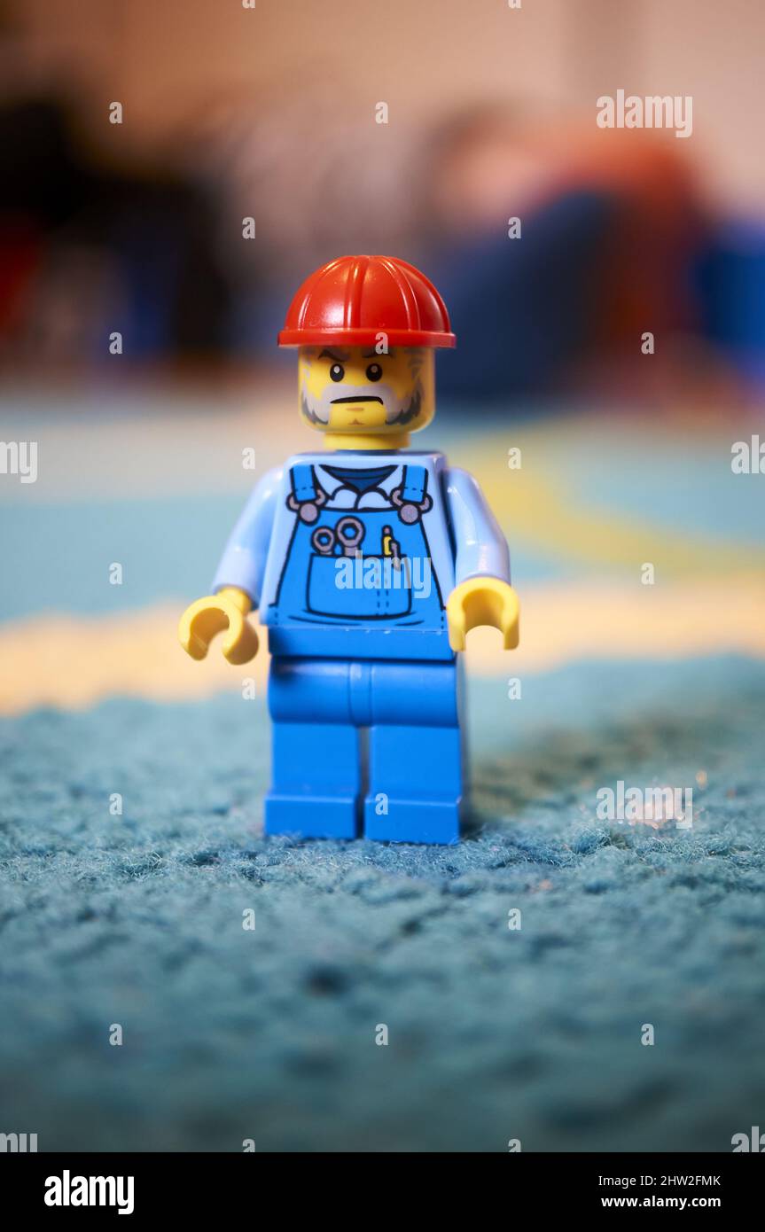 Vertical shot of a construction worker toy figure team with red helmets ...