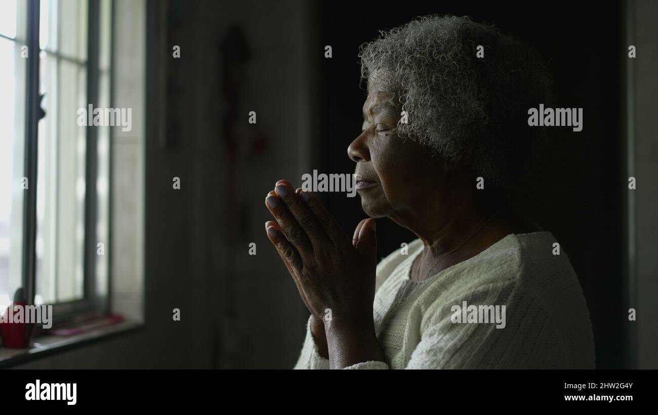 A spiritual African woman praying to God with HOPE Stock Photo - Alamy
