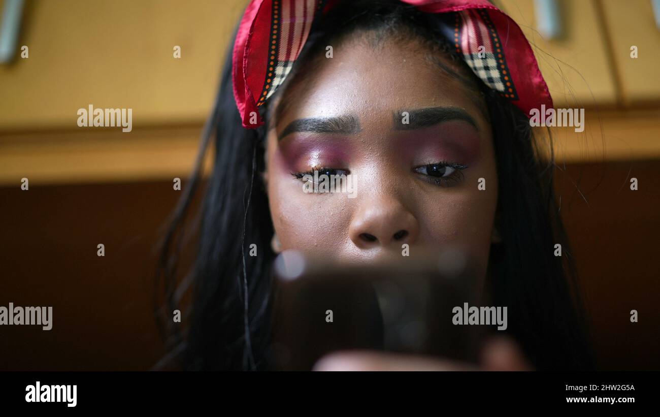 A teenager looking at phone screen closeup eyes staring at cellphone ...