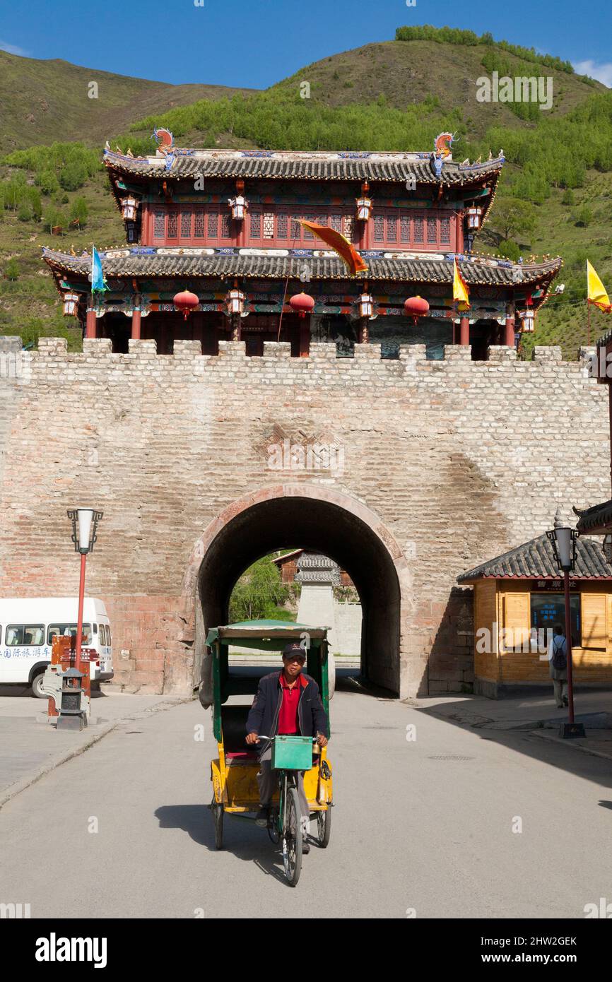 East Gate 'Jinyang Gate' of Songpan, with rickshaw cyclist and bicycle ...