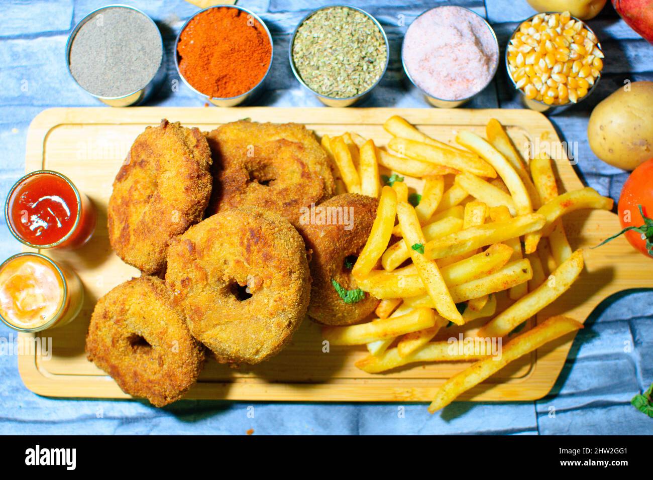 French fries with cutlets and sauces on wooden serving board Stock ...