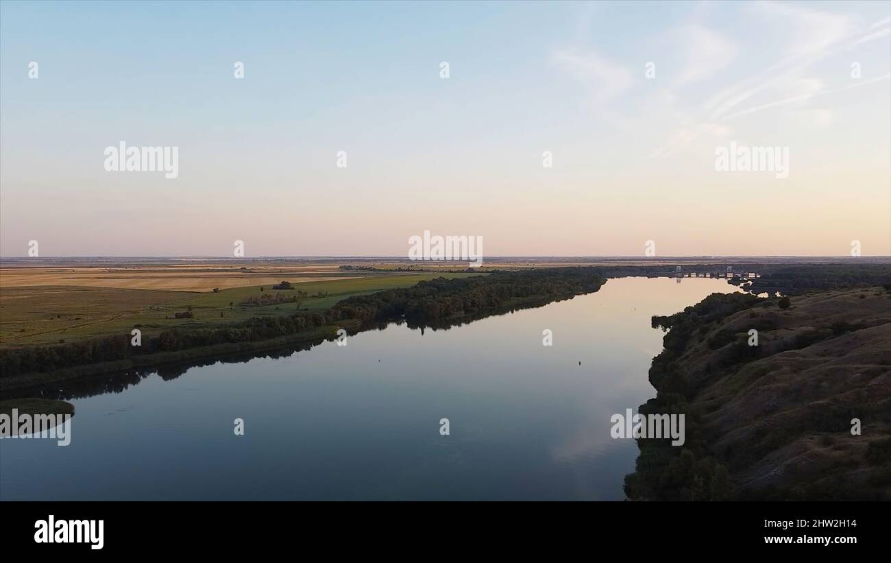 Beautiful panorama of river going to horizon and reflecting blue sky ...