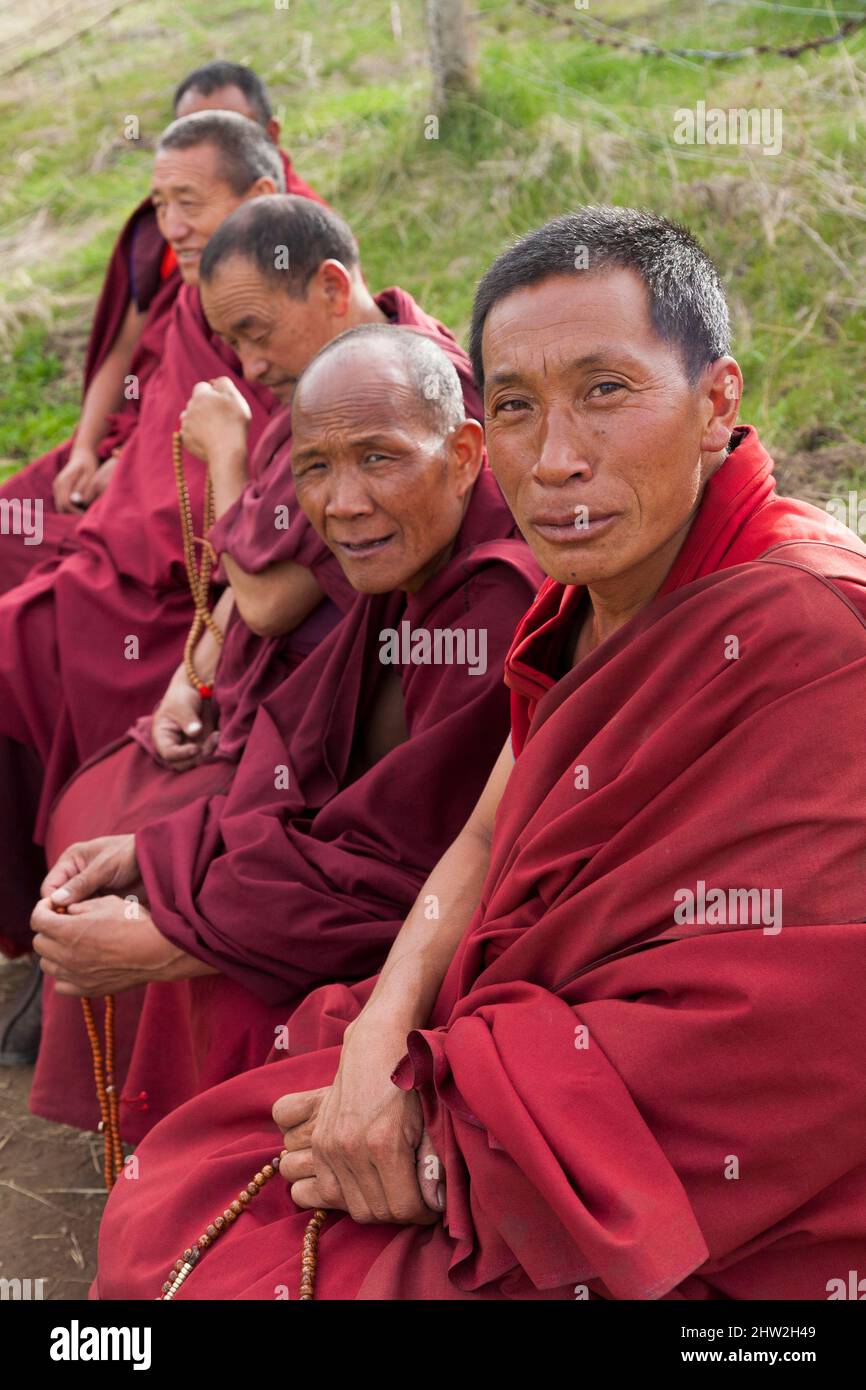 Buddhists monks, all male / middle aged men, talk, sit and relax near ...