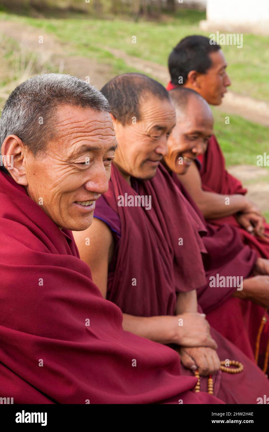 Buddhists monks, all male / middle aged men, talk, sit and relax near ...