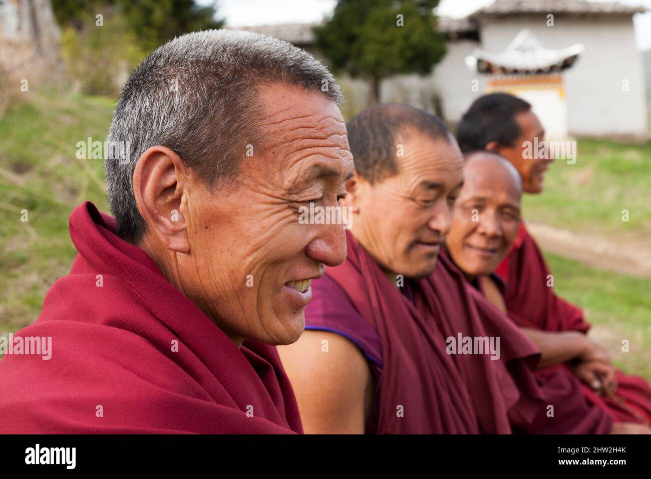 Buddhists monks, all male / middle aged men, talk, sit and relax near ...