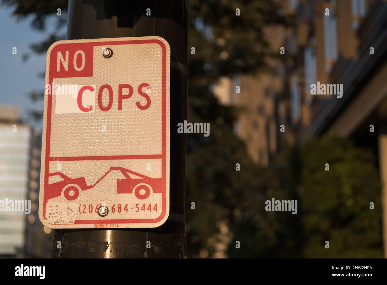 Seattle, USA. 24 Jun, 2021. A sticker on a parking sign that reads no ...