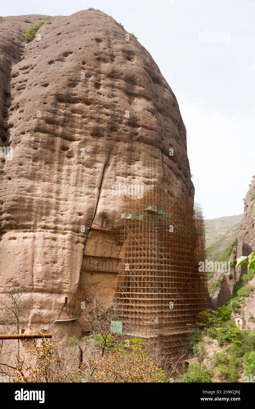 Scaffold / scaffolding on the mountain side where ancient caves were ...