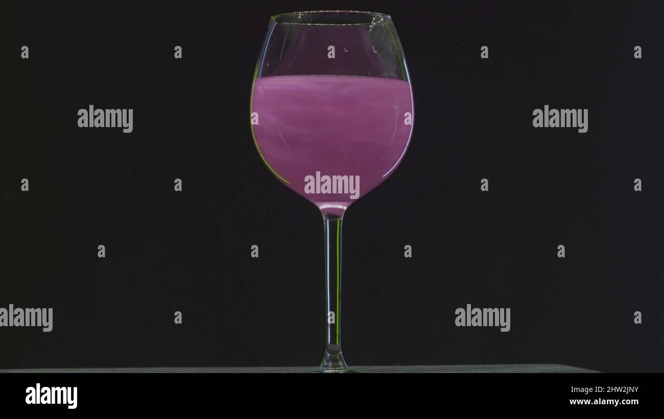 Drink shimmers in a glass on isolated background. Stock footage ...
