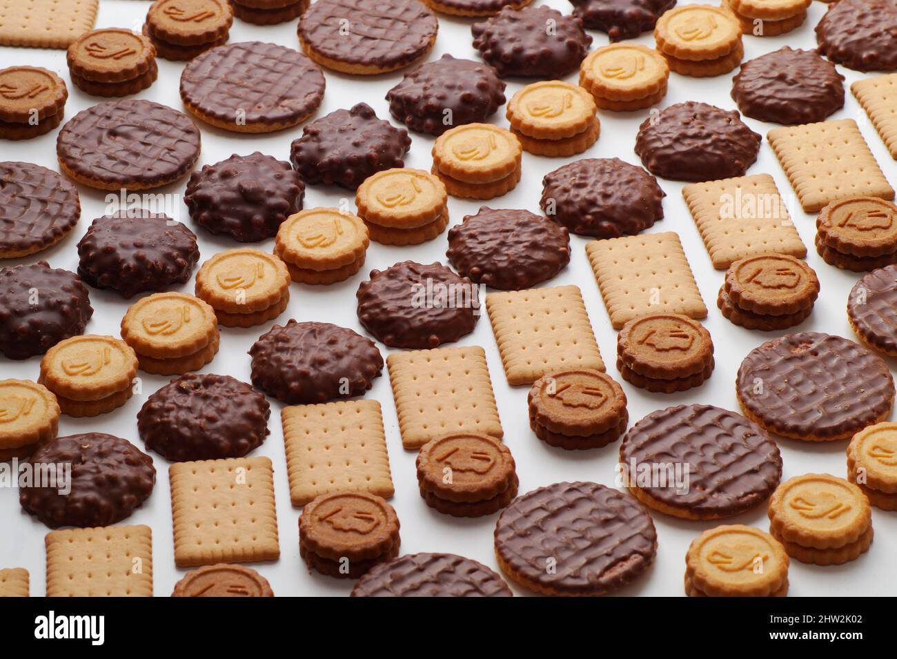 Pattern of cookies of different types and shapes stacked in even rows ...