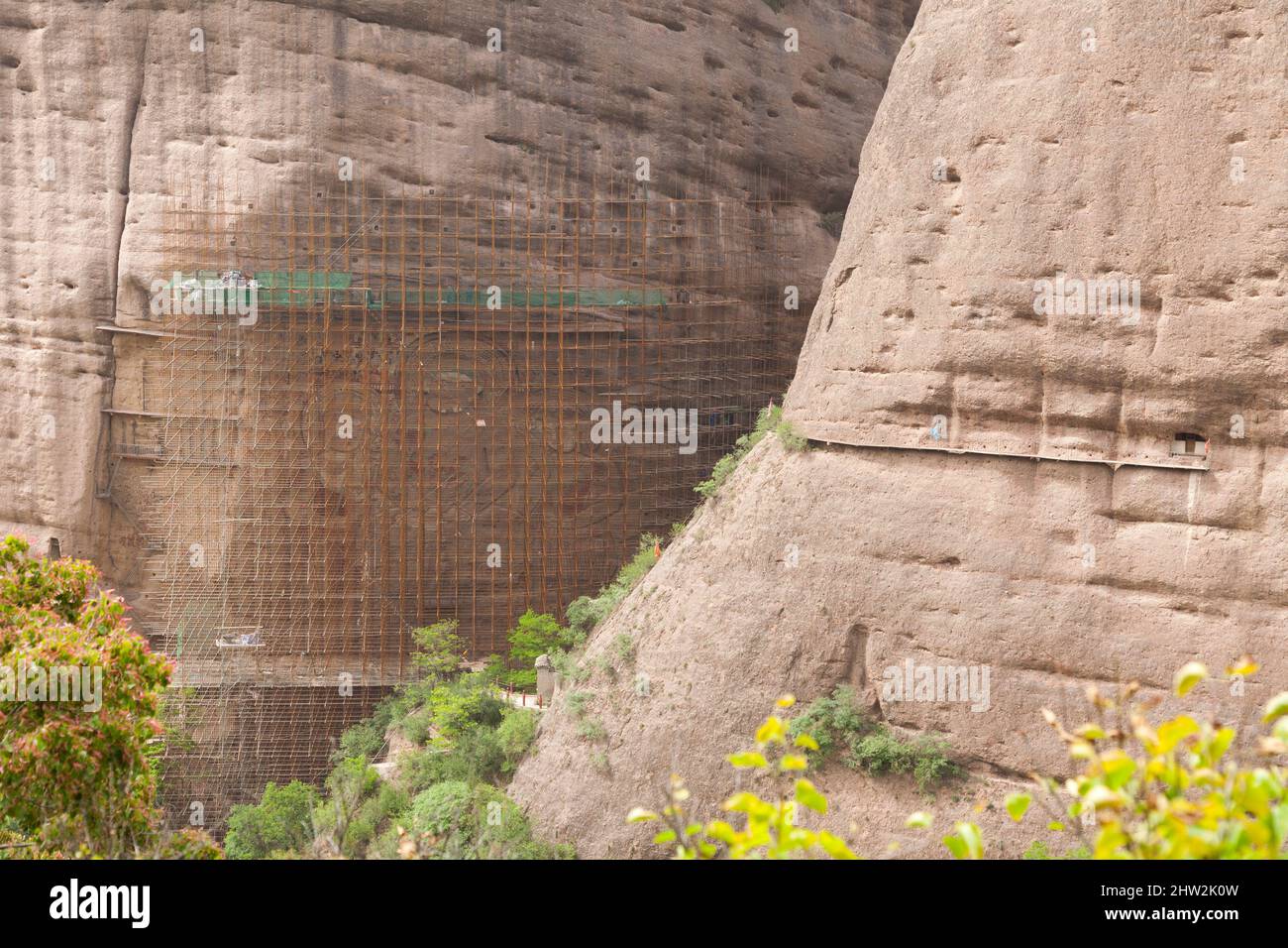 Scaffold / scaffolding on the mountain side where ancient caves were ...
