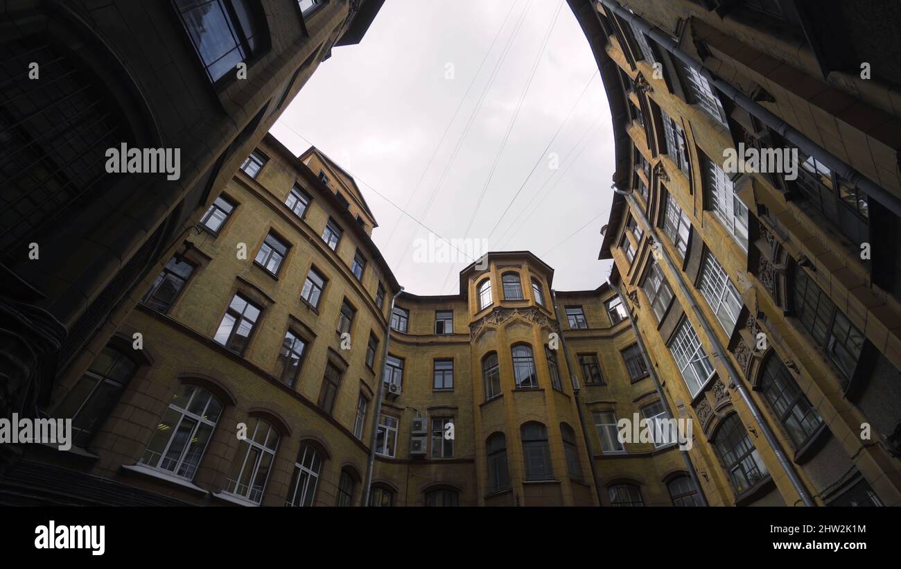 Courtyard of old round building in city. Action. Bottom view of old ...
