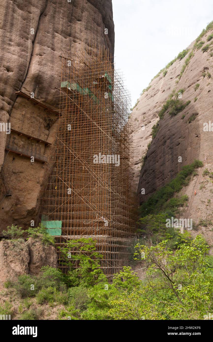 Scaffold / scaffolding on the mountain side where ancient caves were ...