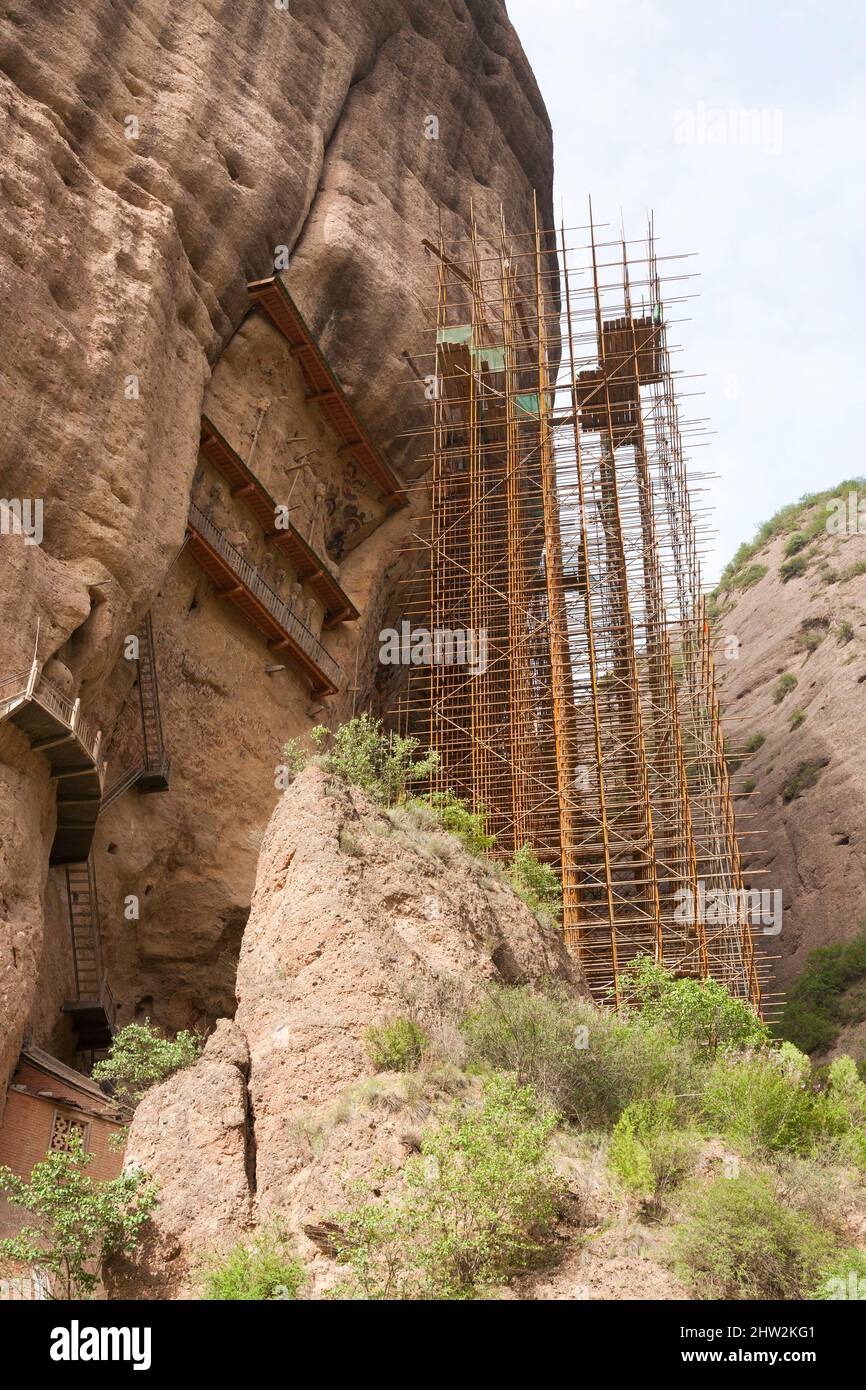 Scaffold / scaffolding on the mountain side where ancient caves were ...