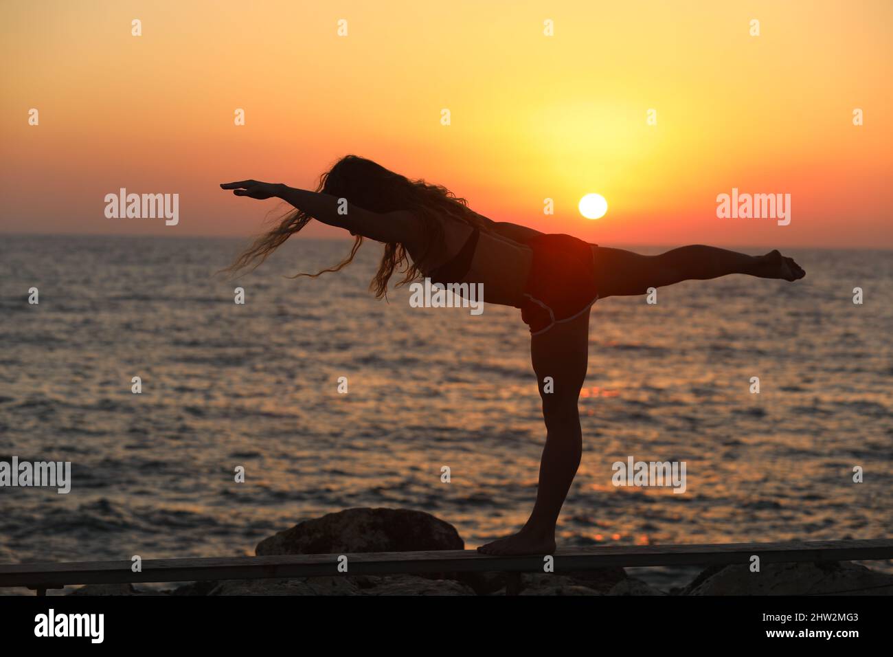 Silhouette of a woman dancing against a sea background Stock Photo - Alamy