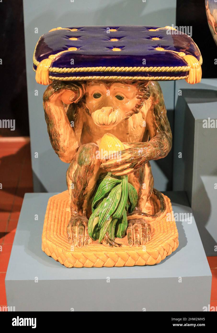 A Minton Pottery majolica garden seat in the shape of a monkey on ...