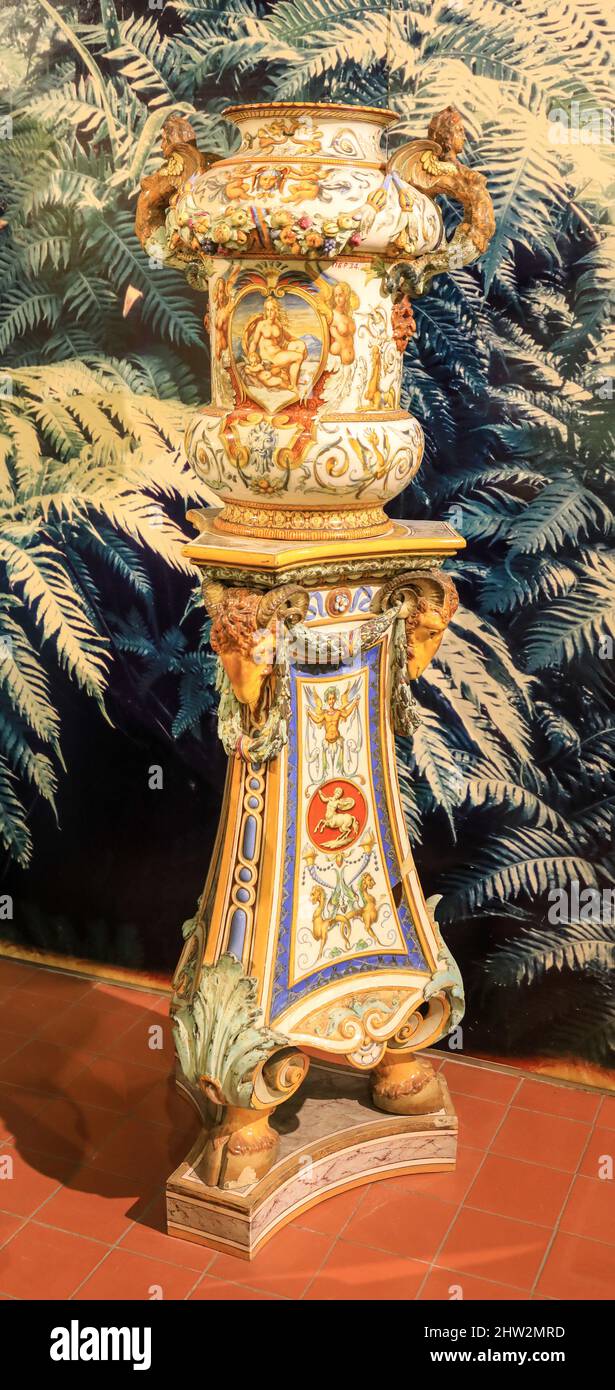 A Minton Pottery majolica vase moulded with rams heads and vines on ...