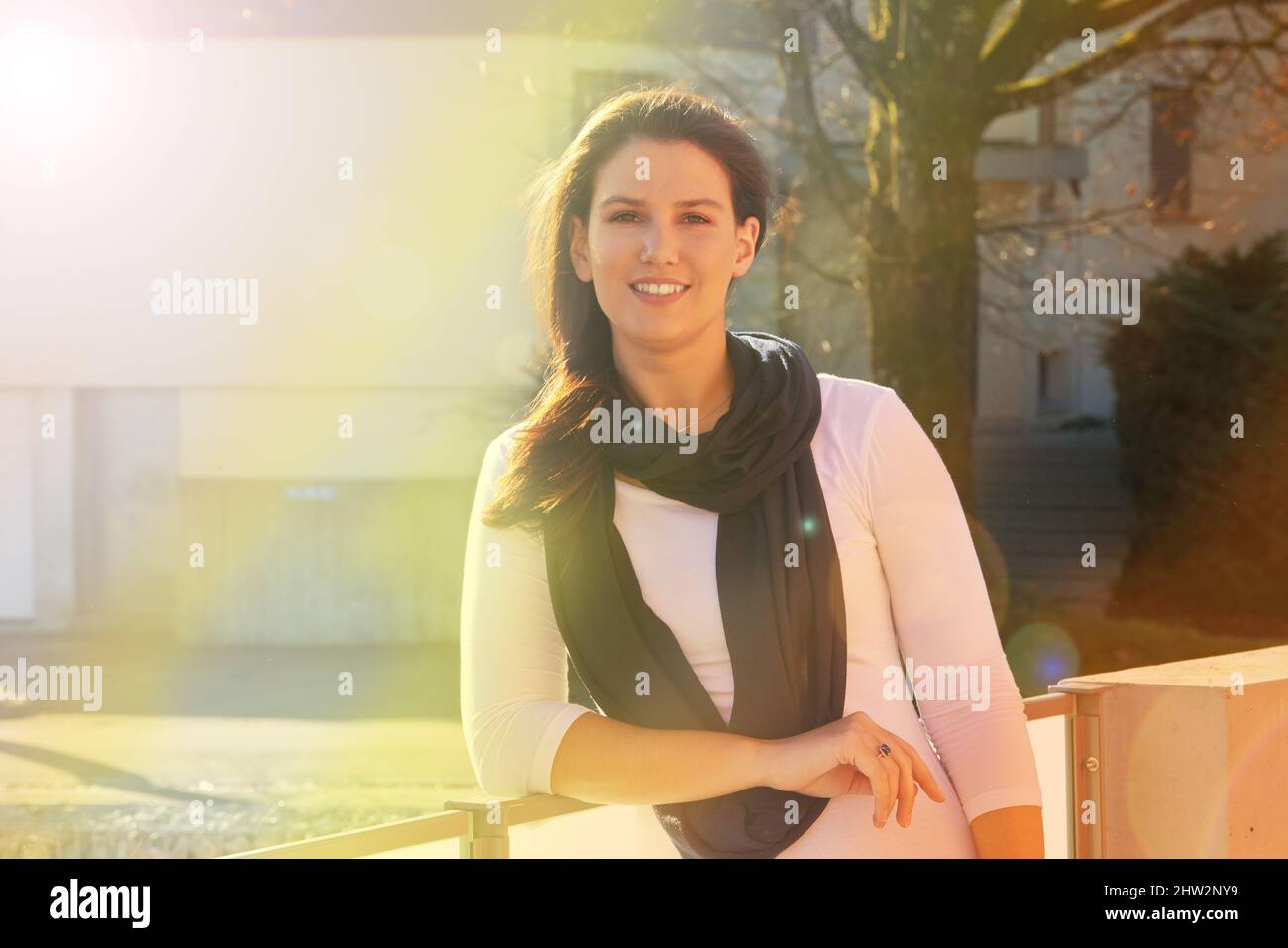 Happy and beautiful. Portrait of an attractive woman standing outside ...