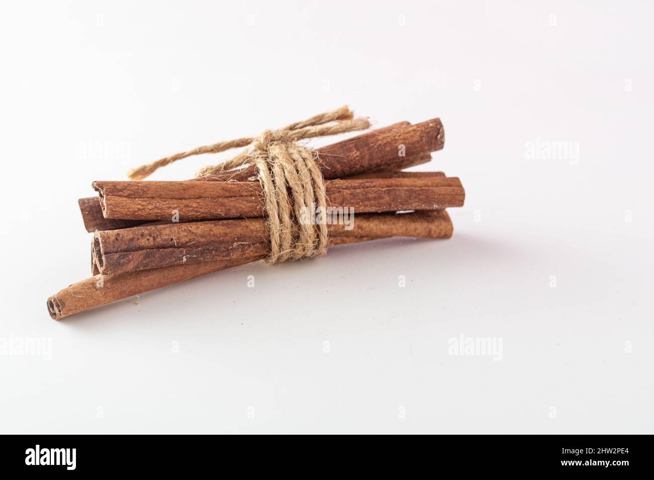 Several cinnamon sticks. Cinnamon in a pile. A bunch of cinnamon tied ...