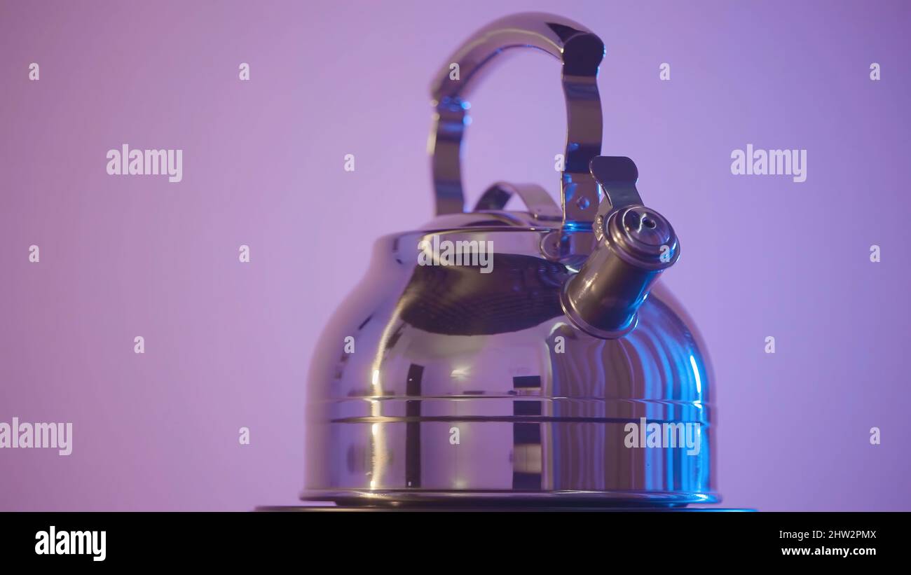 Metal teapot on isolated background. Action. Beautiful shiny kettle for ...