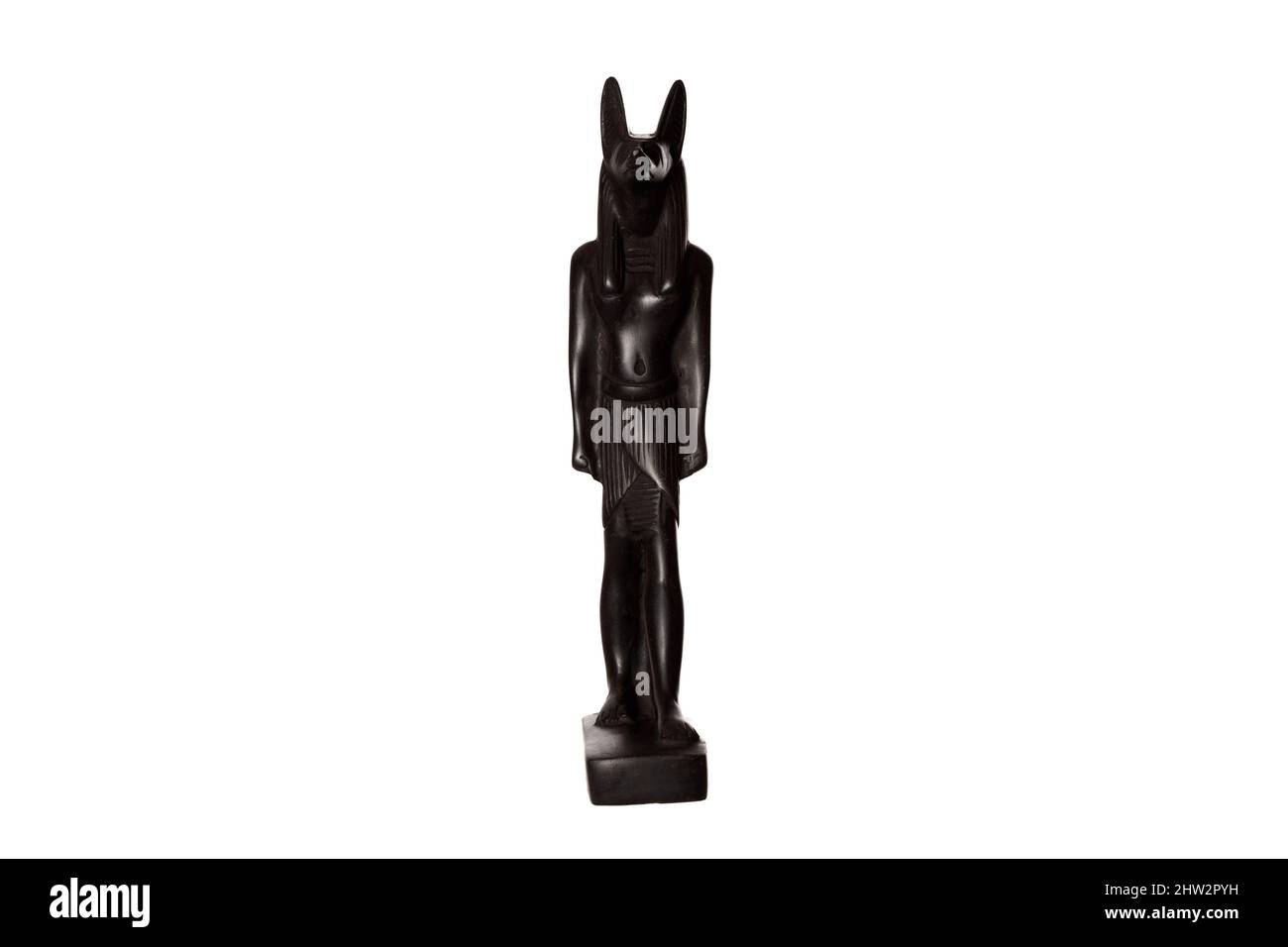 black figurine of the Egyptian god Anubis with the head of a jackal isolated on a white ...