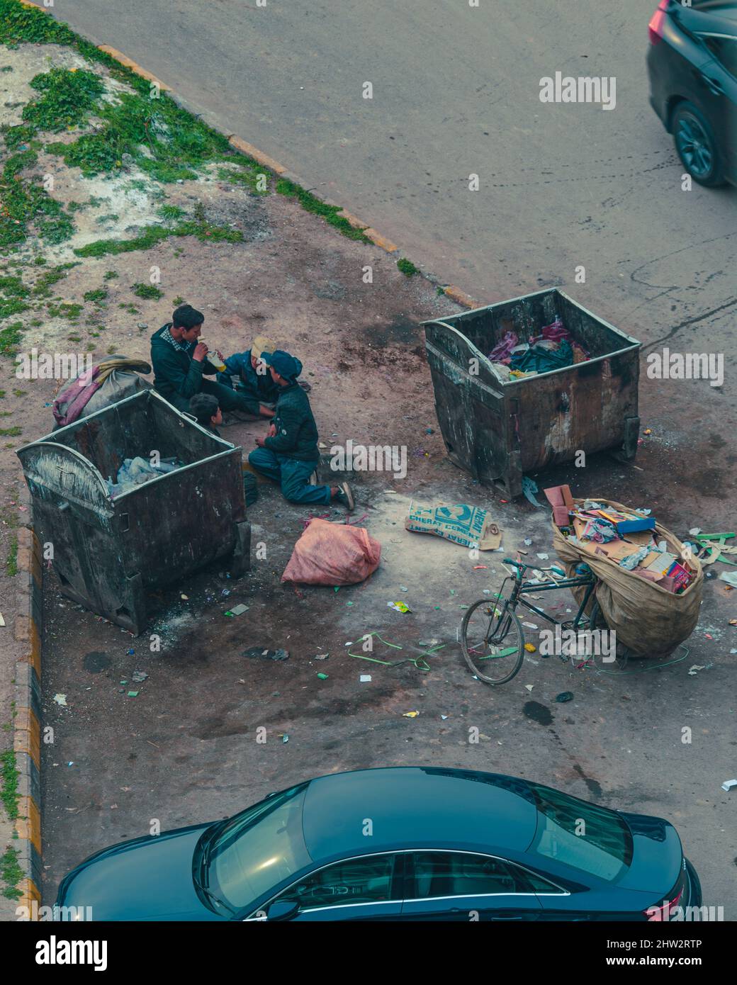 poor kids eating near garbage carts Stock Photo - Alamy