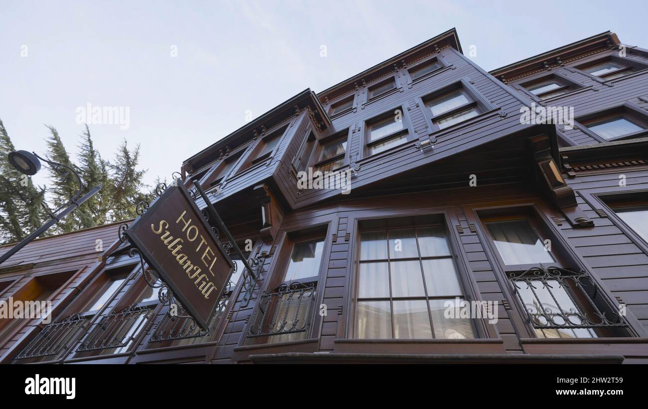 Bottom view of European house in town in summer. Action. European ...