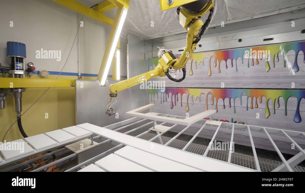 Industrial robotic arm paint frame. Action. Automated robotic arm ...