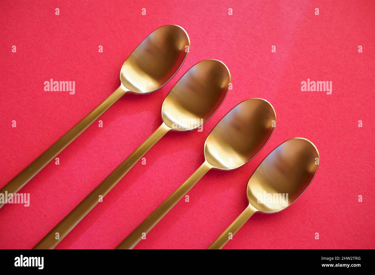 Top view of teaspoons on a red background Stock Photo - Alamy