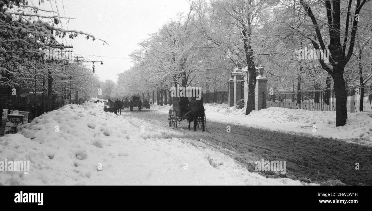 1930s, historical, wintertime and people on a horse-drawn carriage ...