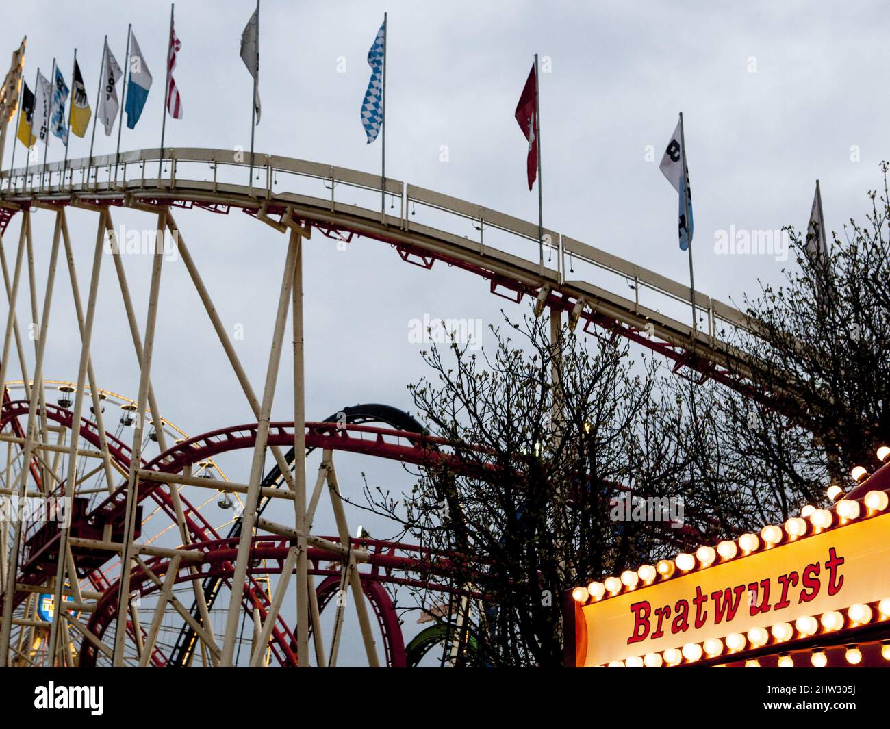 View of an attraction with flags in an amusement park Stock Photo - Alamy