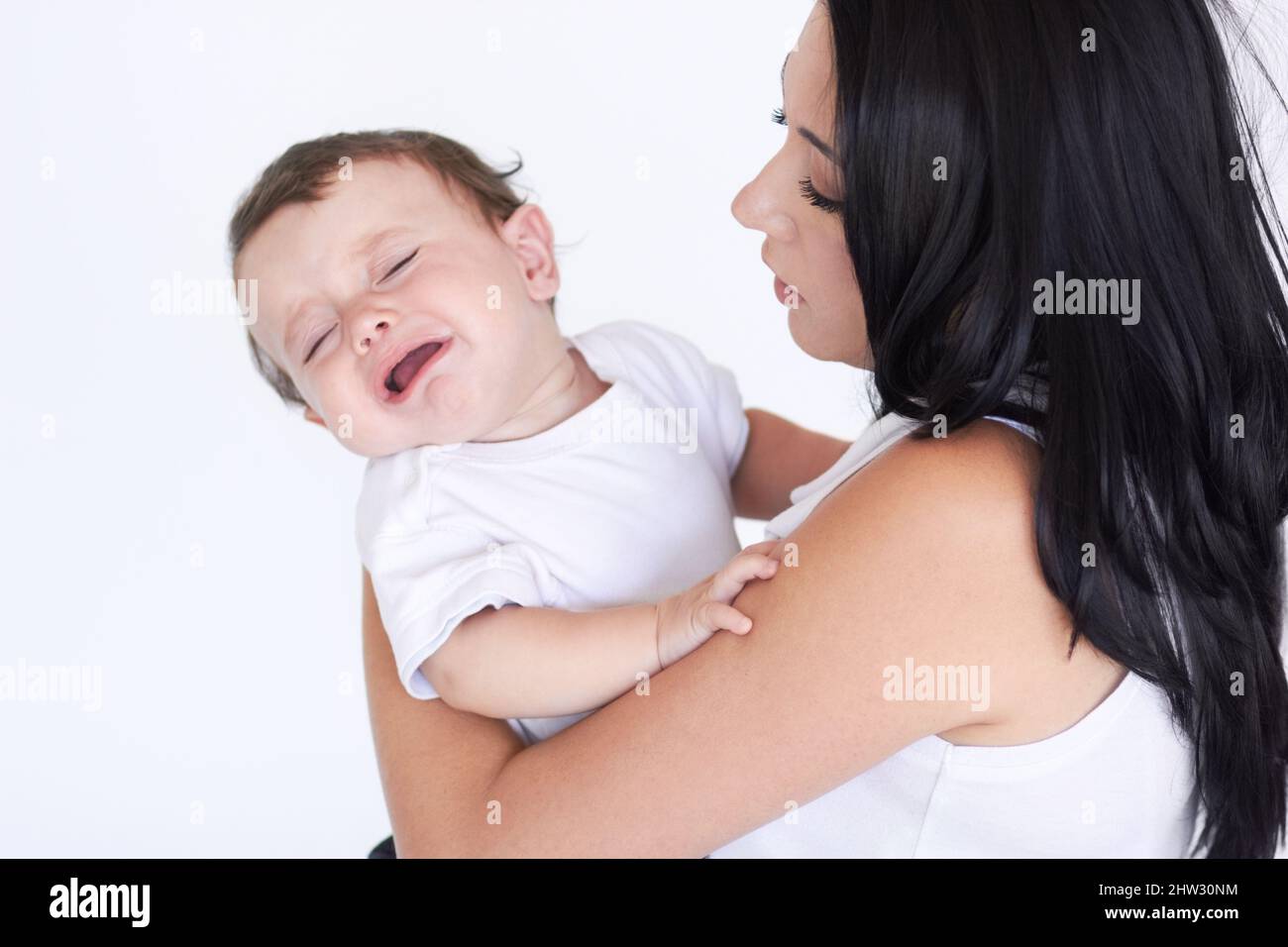 Babies are hard work. A mother holding her crying baby boy Stock Photo ...